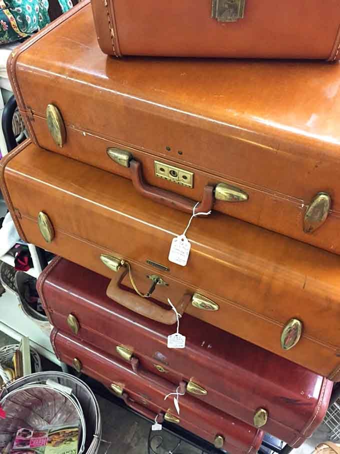 Vintage luggage stacked like a leather tower of travel dreams, each piece holding stories from journeys long past.