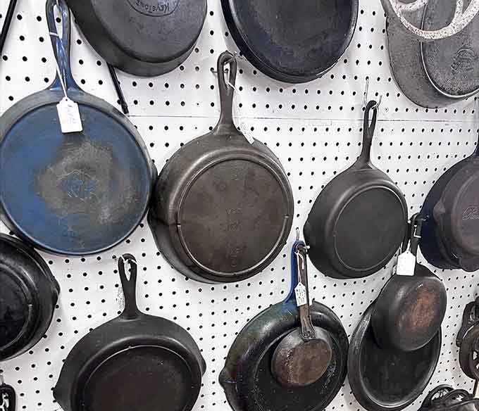 Cast iron skillets lined up like old soldiers, each one seasoned with decades of Sunday morning breakfasts.