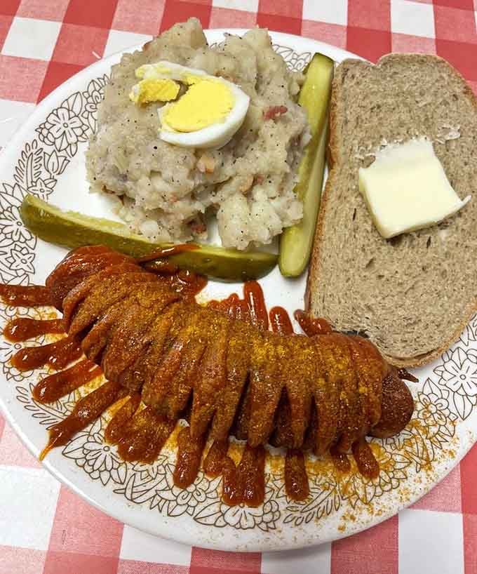 Currywurst arrives scored and sauced, a street food legend that somehow landed perfectly in Indianapolis.