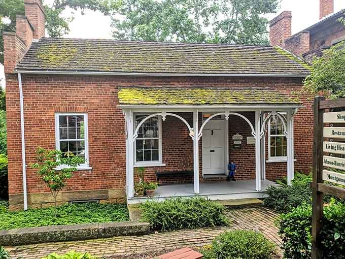 Moss-covered rooftop, arched white porch, and a brick path that practically begs you to slow down.