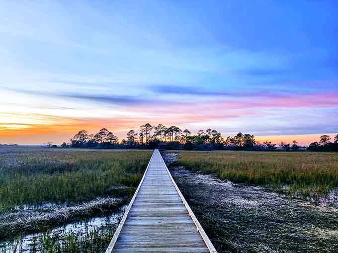 This boardwalk leads straight into a sunset that'll make your camera roll very, very happy. Nature's own masterpiece.