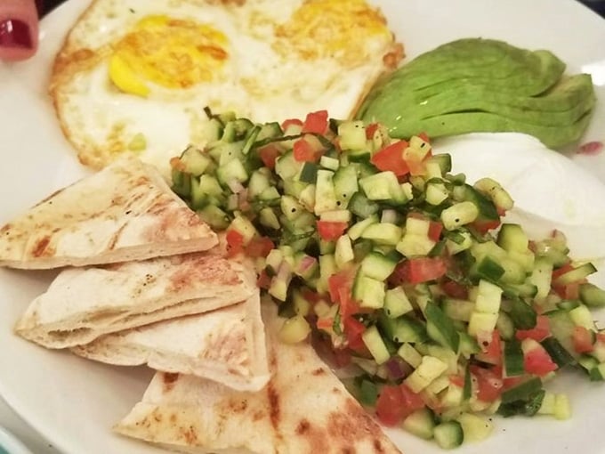 Sunny-side eggs, fresh cucumber salsa, avocado, and warm pita. This breakfast plate is genuinely life-affirming.