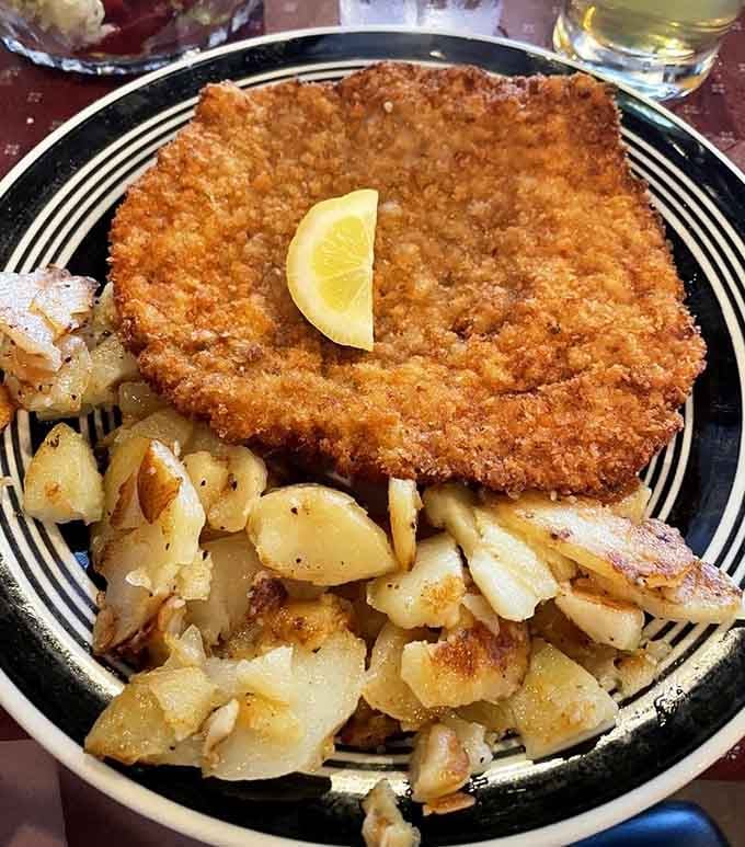 Golden, crispy, and crowned with a lemon wedge, this schnitzel isn't playing games with anyone.