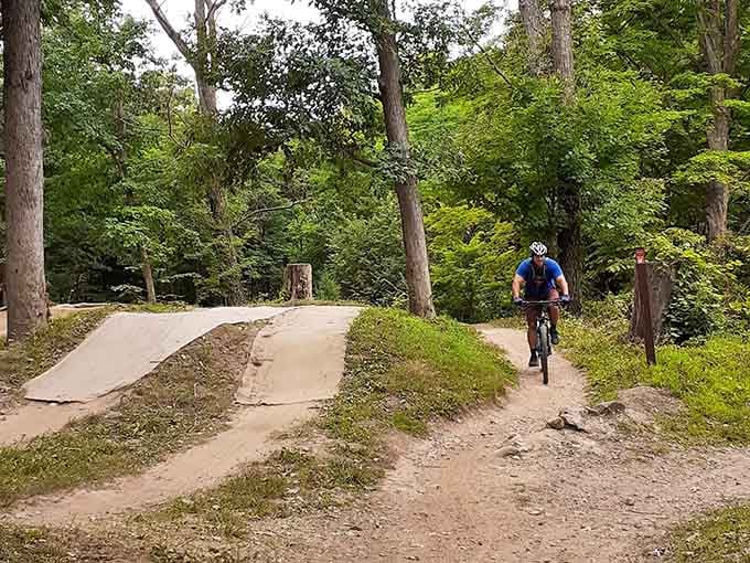 A rider navigates the wooded trail, proving that adventure doesn't require a plane ticket or a passport.