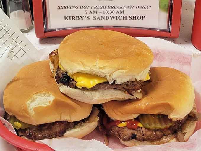 Three burgers in a basket, sitting together like old friends who know exactly what they're doing.