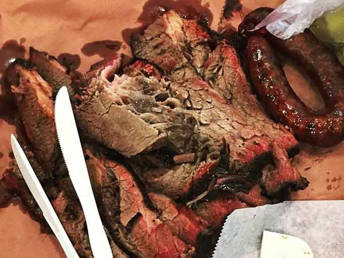 Brisket and sausage on butcher paper. No plate needed, no apology offered, and absolutely none required.