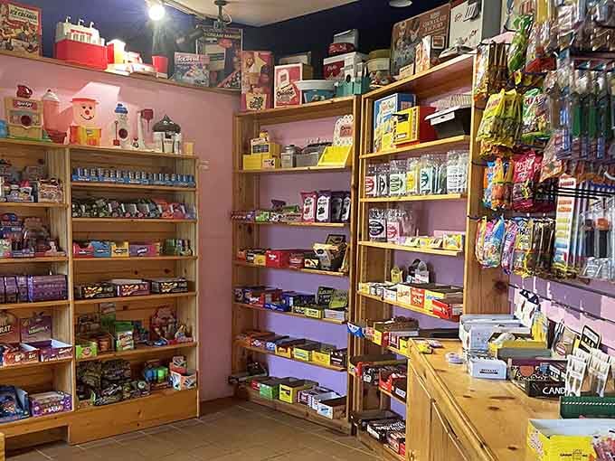 Pink walls lined with nostalgic treasures prove that candy stores are basically time machines with better lighting.