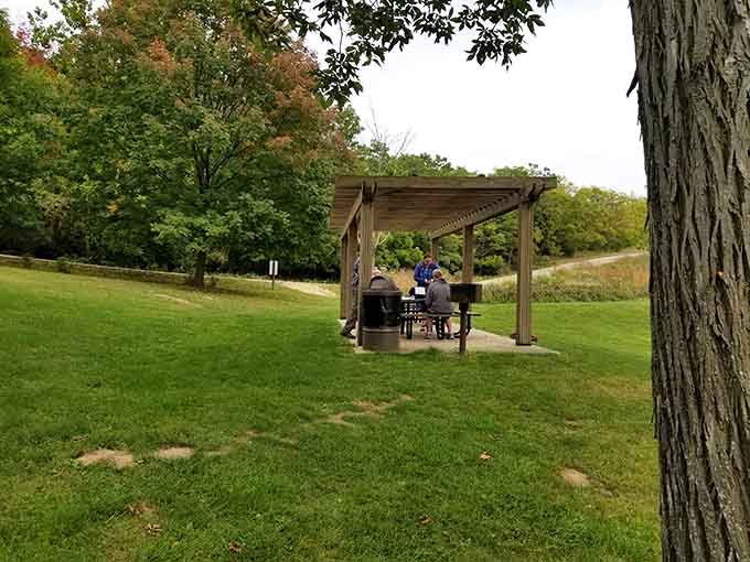 A covered picnic spot, good company, and trees putting on their fall wardrobe. Someone clearly had their priorities straight.