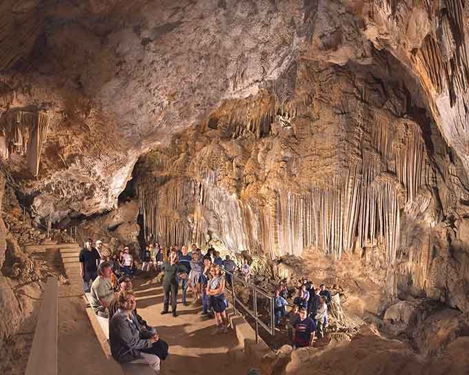 When the guide starts talking, even the most restless visitors go completely quiet. The cave has that effect.