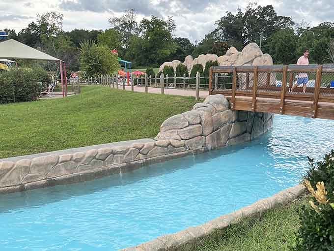 Still water mirrors a sky full of drama, and somewhere behind those trees, a water slide is calling your name.