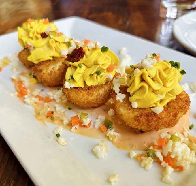 Fried deviled eggs dressed up with Nduja sausage and 1000 Island. Your grandmother's recipe never stood a chance.
