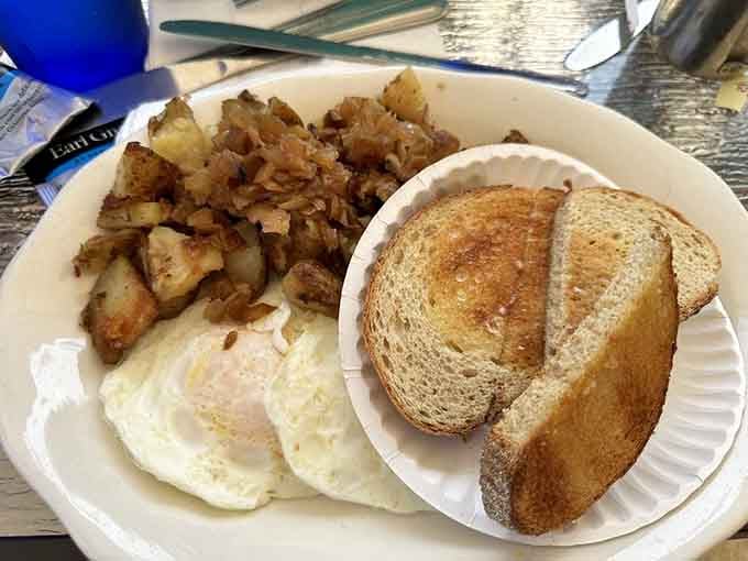 Two eggs, home fries, and toast: the holy trinity of breakfast done exactly as it should be.