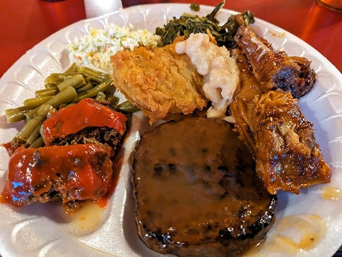 A plate so loaded with meatloaf, fried chicken, collard greens, and more, it deserves its own zip code.