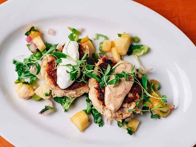 Golden, seared crab cakes crowned with mango salsa and fresh herbs, proof that Minnesota can do coastal cuisine proud.