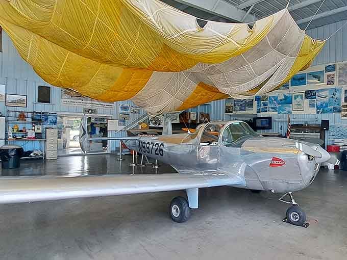 That sleek silver beauty looks ready to take flight at any moment, parachute billowing overhead like captured sunshine.