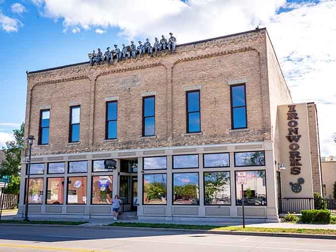 Ironworks on Main earns its name with those rooftop figures keeping watch over downtown like the world's most dedicated neighborhood watch crew.