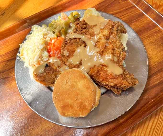 Golden fried chicken with all the Southern fixings, served on pewter plates like proper colonial travelers.