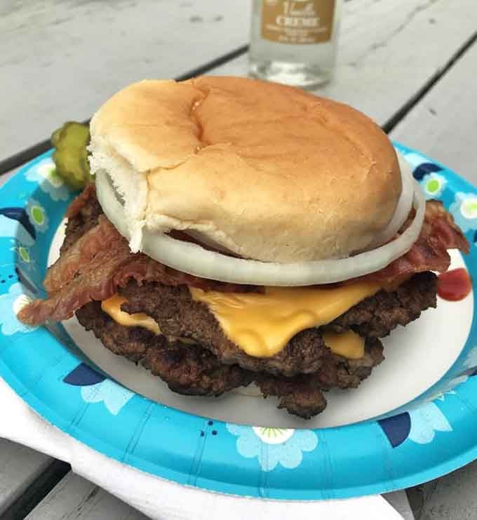Behold the double bacon cheeseburger: two patties, crispy bacon, melted cheese, and pure small-town satisfaction on a bun.