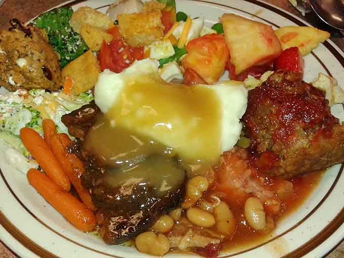 A plate this loaded deserves its own zip code. Meatloaf, mashed potatoes, beans, and more.