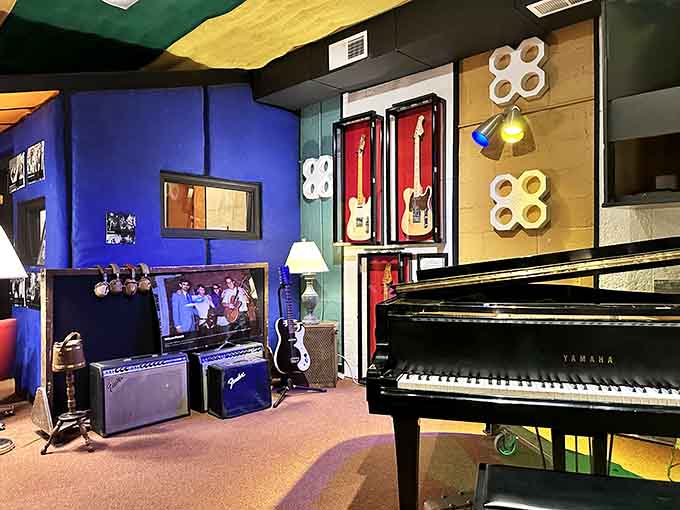 Bold blue walls, a Yamaha grand piano, and guitars displayed like fine art. This room means serious business.
