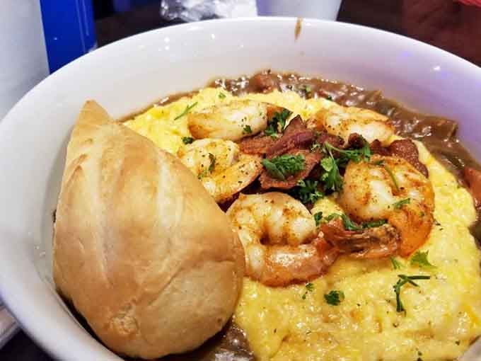 Cheesy grits, jumbo shrimp, rich gumbo, and a roll of bread. This bowl means serious, life-changing business.