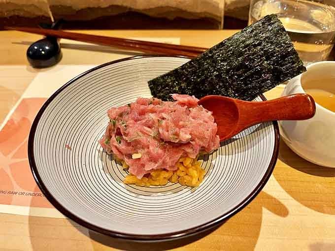 Tuna tartare sitting on uni rice with a crisp nori sail is the kind of dish that makes you put your phone down and just eat.