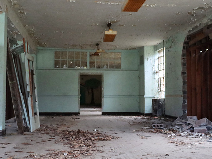 Peeling mint-green walls and debris-covered floors turn this abandoned ward into something straight out of a fever dream.