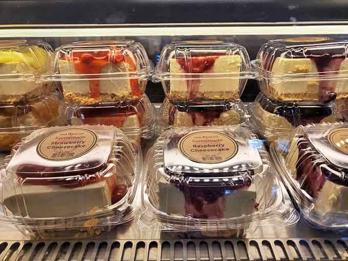 Rows of cheesecakes waiting patiently in their cases, each one a small miracle happening right next to the motor oil aisle.
