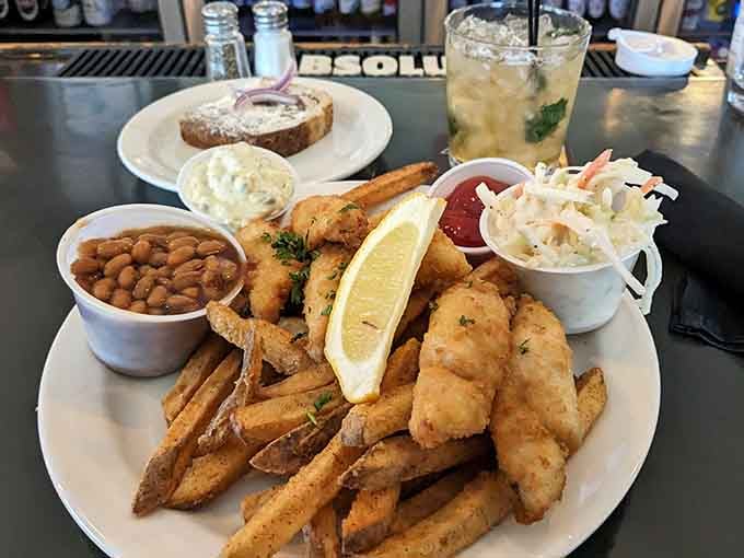 Golden, crispy haddock with a lemon wedge, coleslaw, and baked beans, this plate is a love letter to classic lakeside dining.