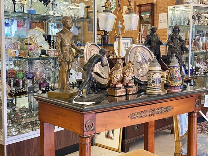 Bronze figures, ornate lamps, and decorative steins gathered on one elegant table, like a very sophisticated yard sale.