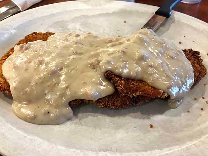 Golden, crispy, and blanketed in peppery white gravy, this country fried steak is the reason road trips were invented.