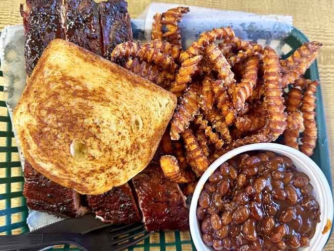 Ribs, crinkle fries, and baked beans on one tray, this plate is pure, unapologetic Southern comfort.