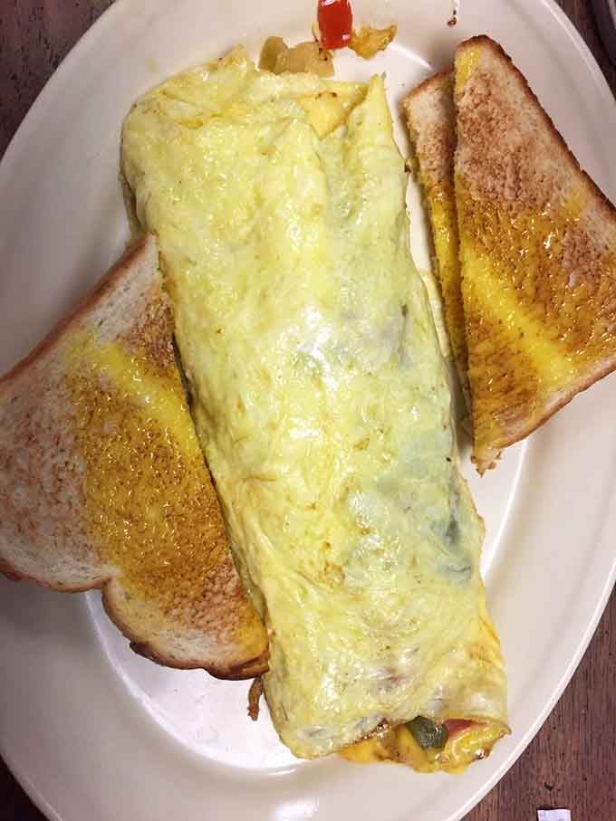 Fluffy, golden, and stuffed with good things. This omelet arrives with toast and absolutely zero apologies for being this generous.