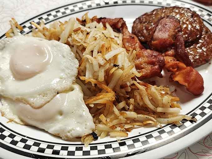 Golden hash browns, a perfectly fried egg, crispy bacon, and a sausage patty. Morning goals, achieved.
