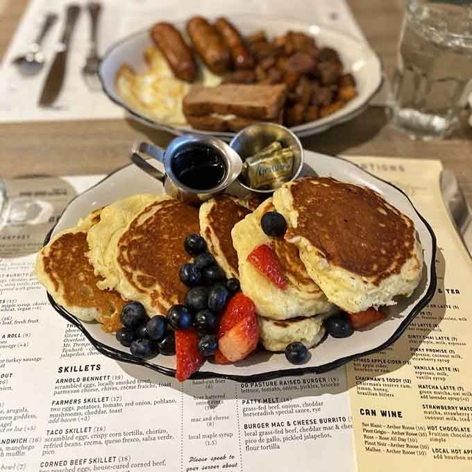 Fluffy buttermilk pancakes with fresh berries prove that simple perfection never goes out of style here.