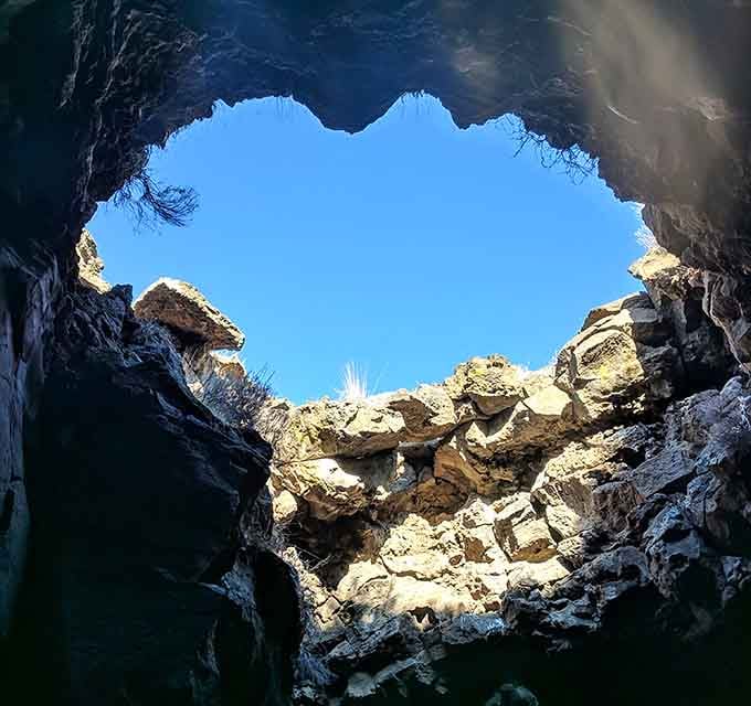 Looking up through the collapsed ceiling feels like peering through a geological skylight into ancient history itself.