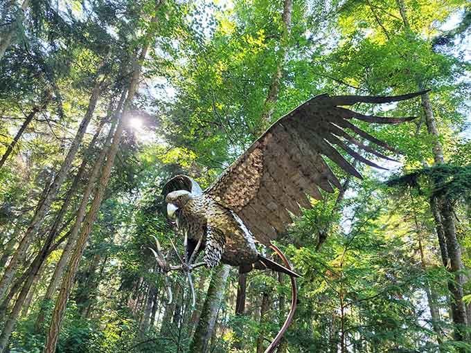A massive metal eagle frozen mid-flight above the treetops, looking absolutely ready to steal your lunch and your heart.