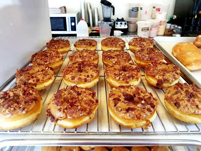Maple bacon donuts cooling on the rack like edible proof that sweet and savory can live together in perfect harmony.