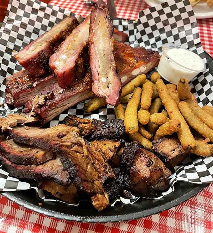Ribs, brisket, and fried green beans sharing one glorious plate, because why choose when you can have everything?