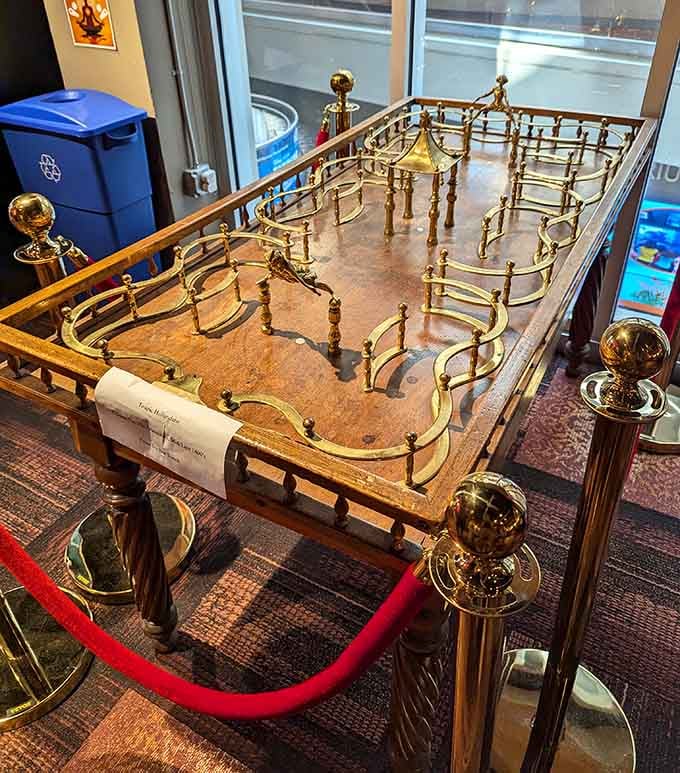 This ornate brass table game is the great-great-grandfather of every pinball machine in the building, and it knows it.