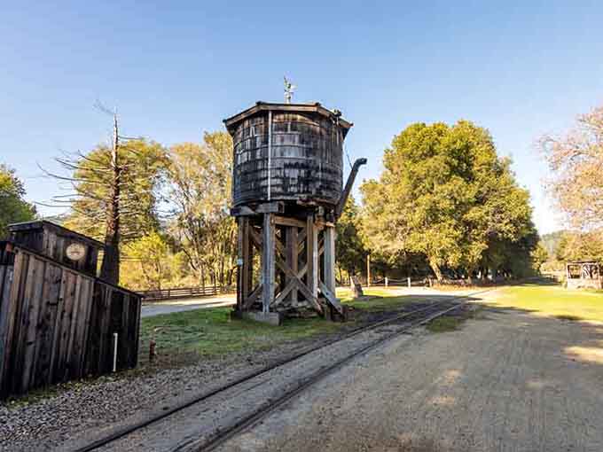 That vintage water tower isn't just decoration. It's a working piece of railroad history standing tall against a perfect blue sky.