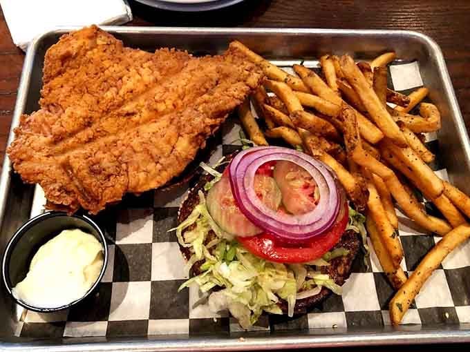 That golden, crispy tenderloin hanging way past the bun is not an accident. It's a promise kept.
