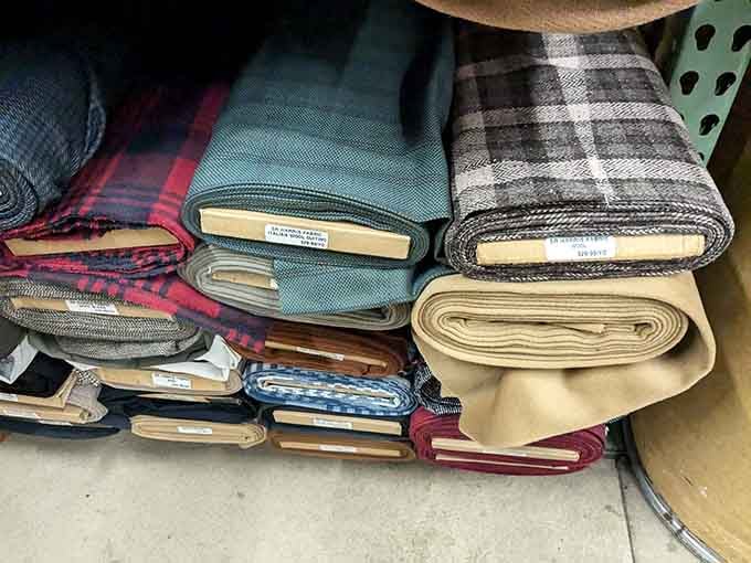 Stacks of rich wool fabrics in plaids and solids, the kind your grandmother would have called "proper material."