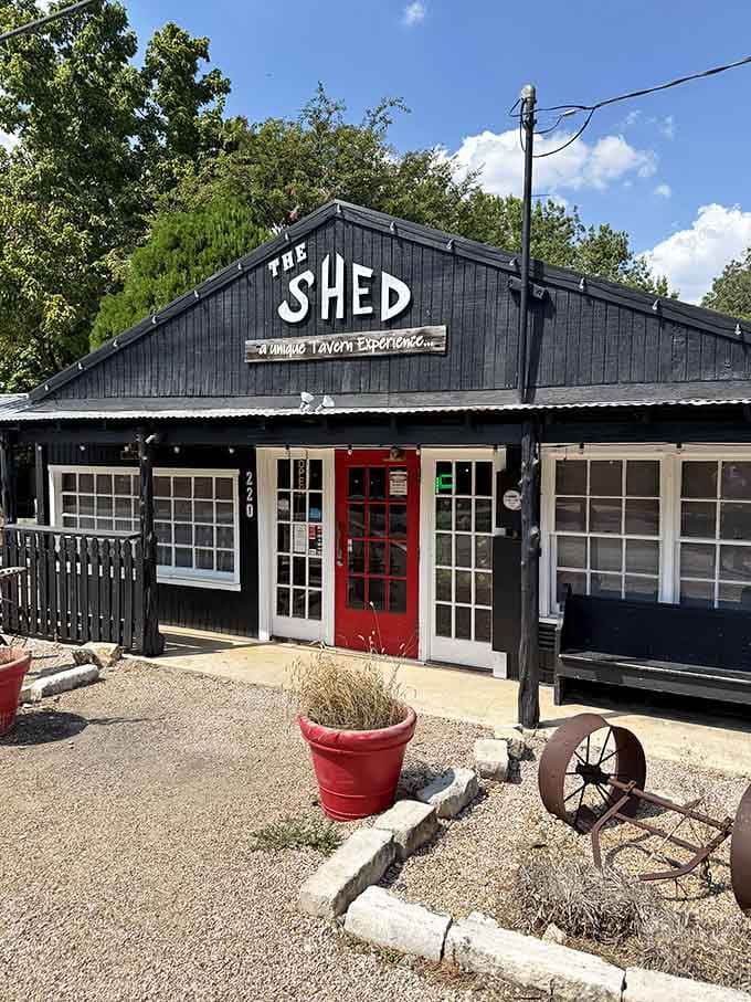 The Shed Tavern proves that the best experiences often come wrapped in black wood and a red door.