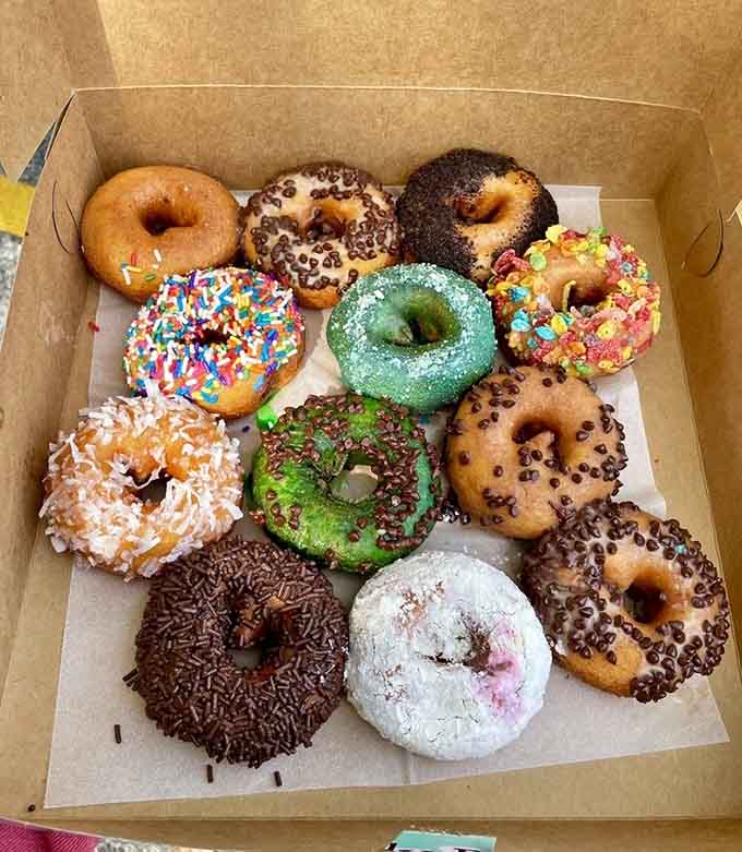 Twelve donuts in a box, each one dressed differently. This is what a good Saturday morning looks like.
