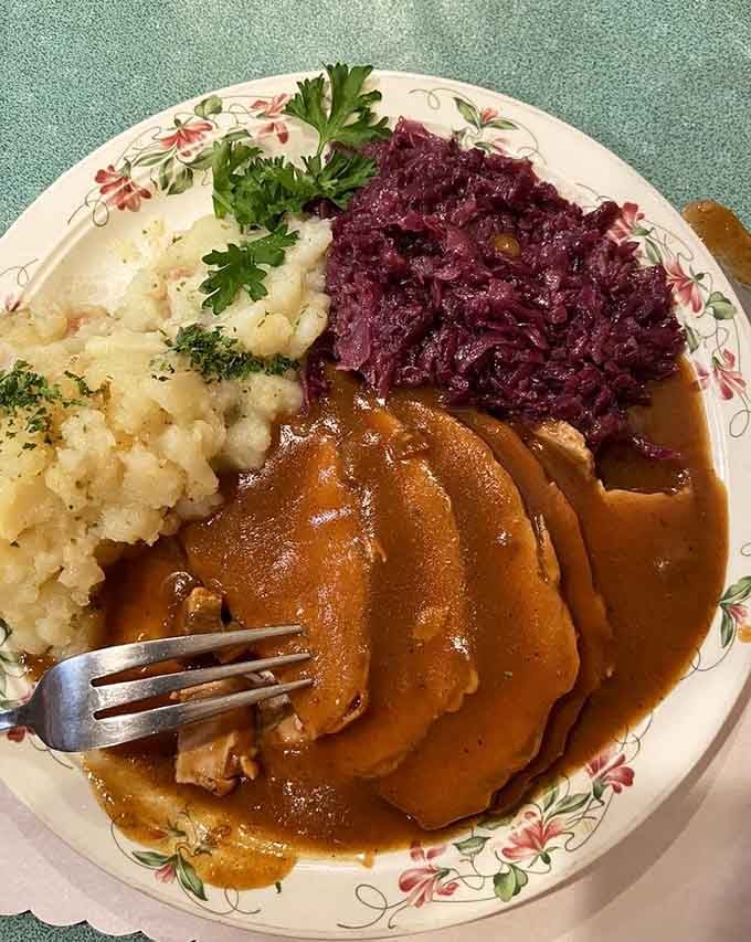 Roasted pork schnitzel swimming in rich gravy, with red cabbage and potatoes alongside. This plate is pure Bavarian comfort.