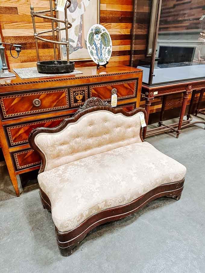 That tufted settee has more elegance in one carved wooden leg than most modern furniture has in its entirety.