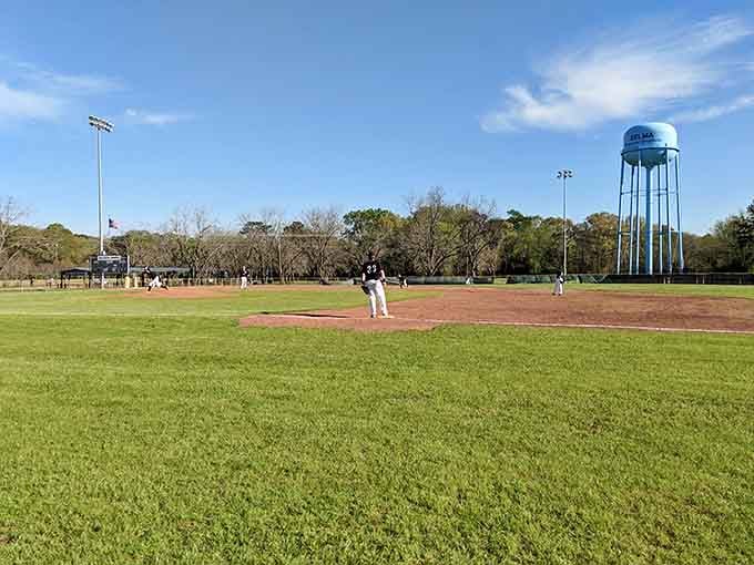 A perfectly green baseball diamond under Alabama's big sky, with a water tower keeping score.