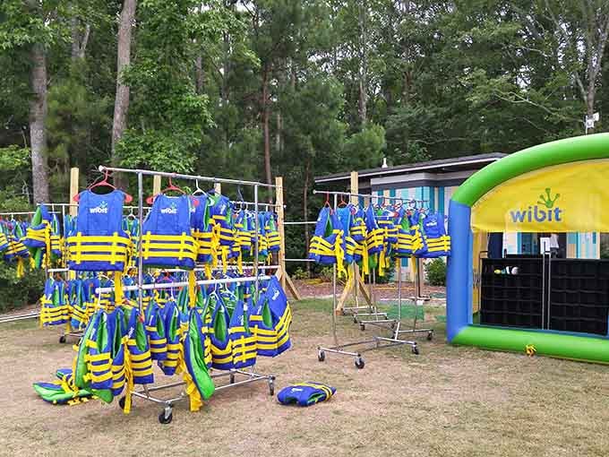Rows of bright life jackets ready to keep you safe while you make questionable decisions on inflatable surfaces.