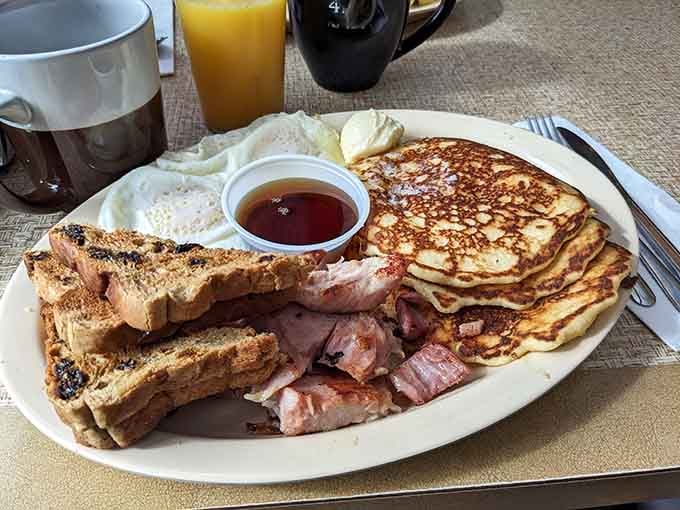 Pancakes, bacon, eggs, and toast arranged like edible architecture, this is breakfast done absolutely right.